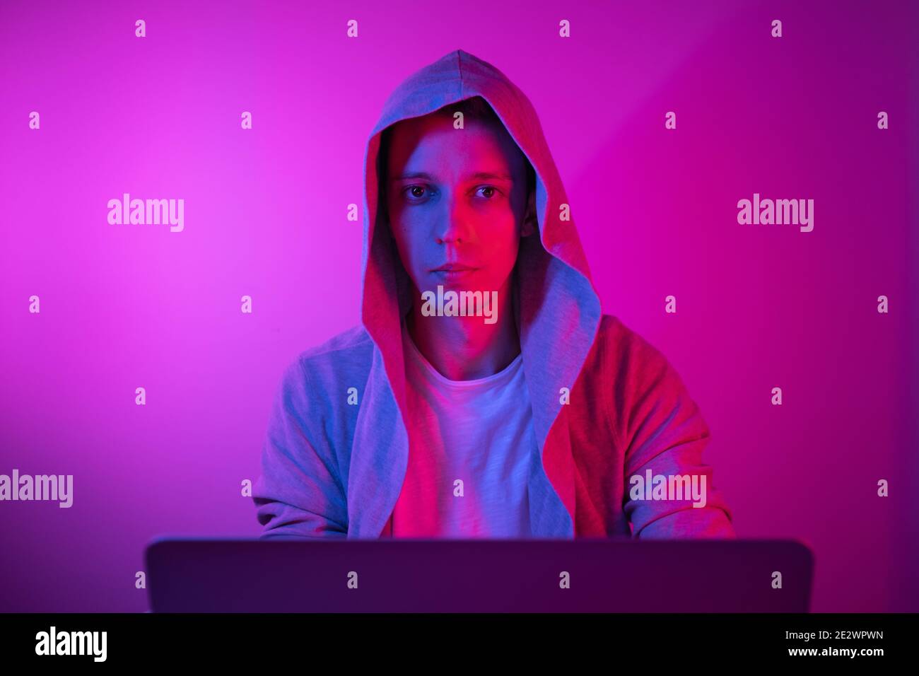 Gamer plays on a laptop. The programmer writes the code. Man on a ...