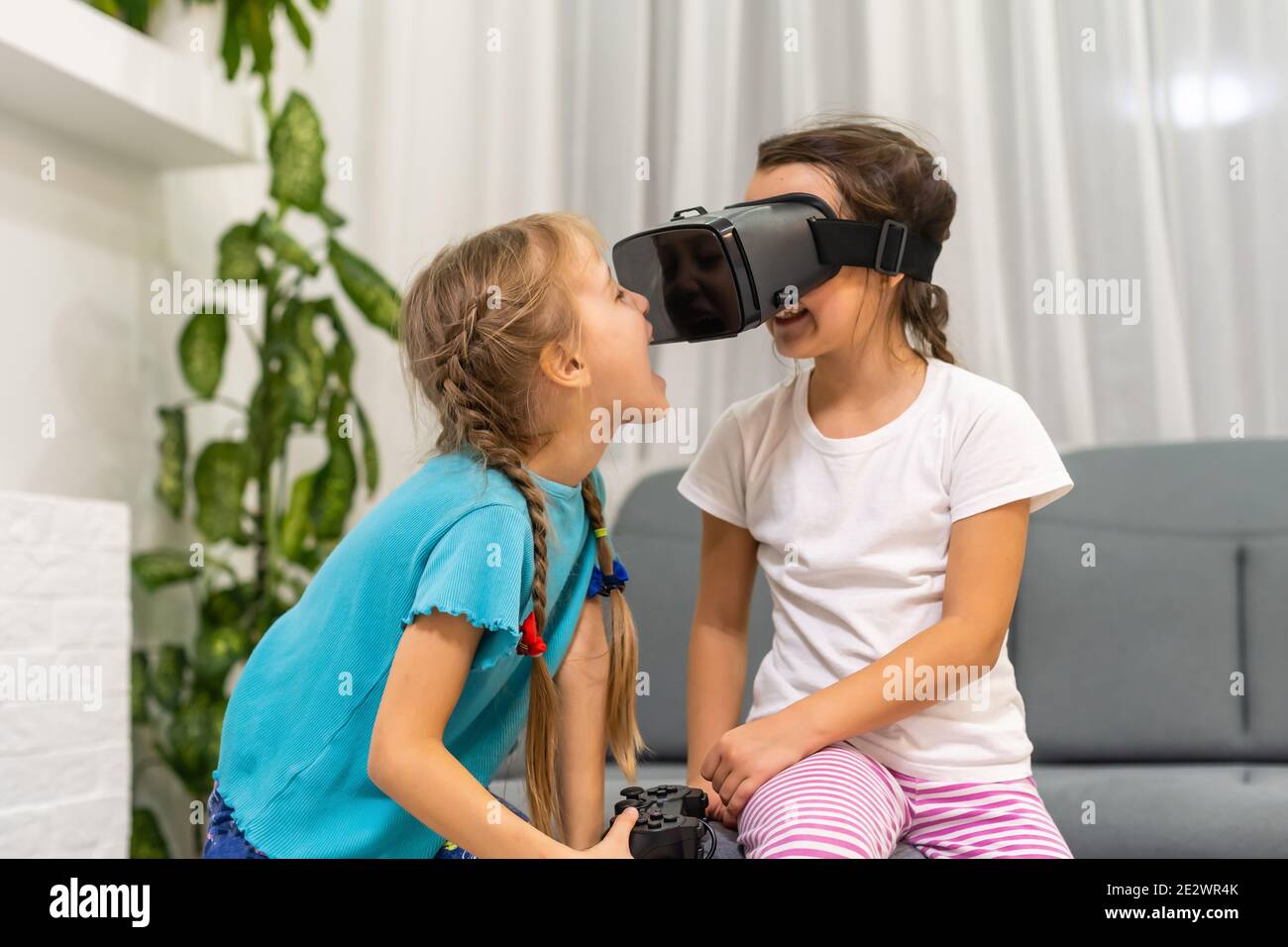 two little girls using glasses of virtual reality headset. concept of ...