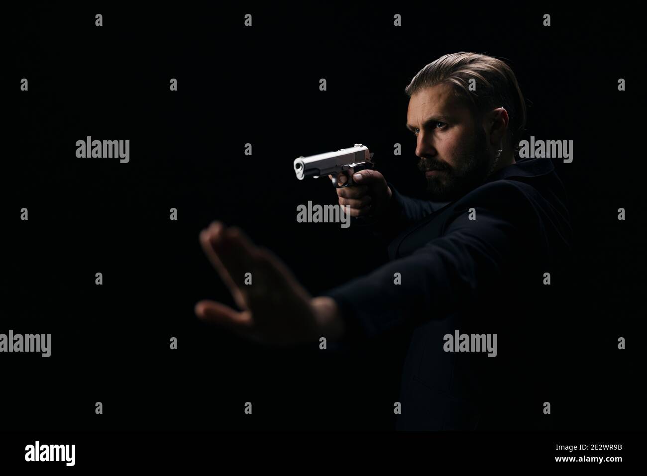 Man with gun showing sign stop with palm Stock Photo - Alamy