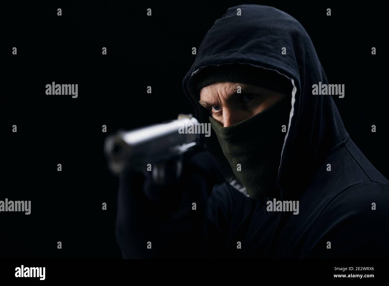 Angry gangster in mask holding weapon Stock Photo - Alamy