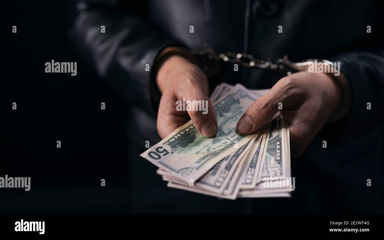 Handcuffs on hands hi-res stock photography and images - Alamy