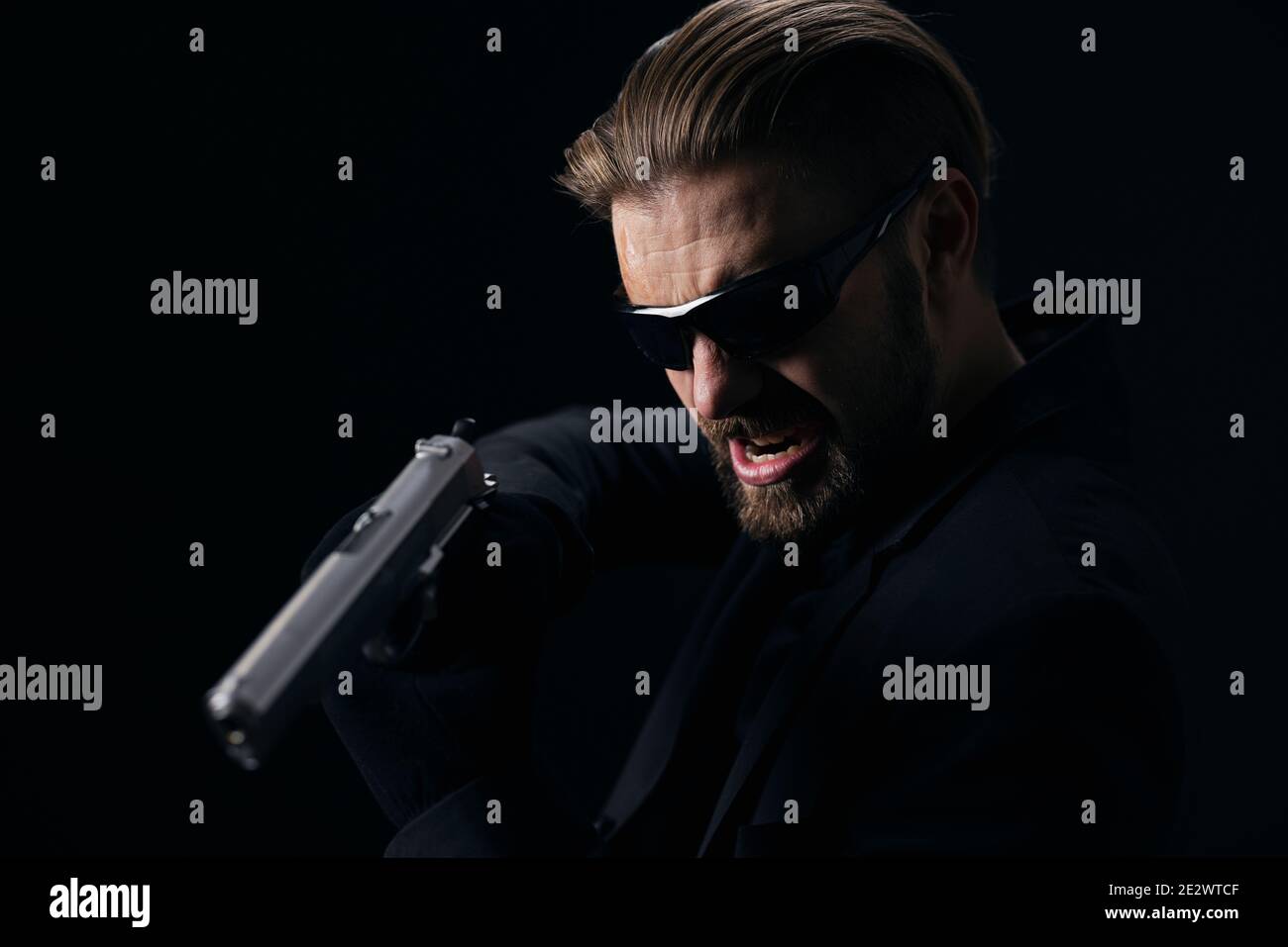 Aggressive man threatening with real gun Stock Photo - Alamy