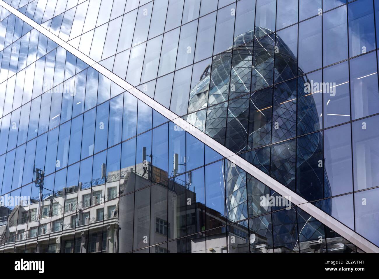 reflection of the gherkin in a glass building, london Stock Photo - Alamy