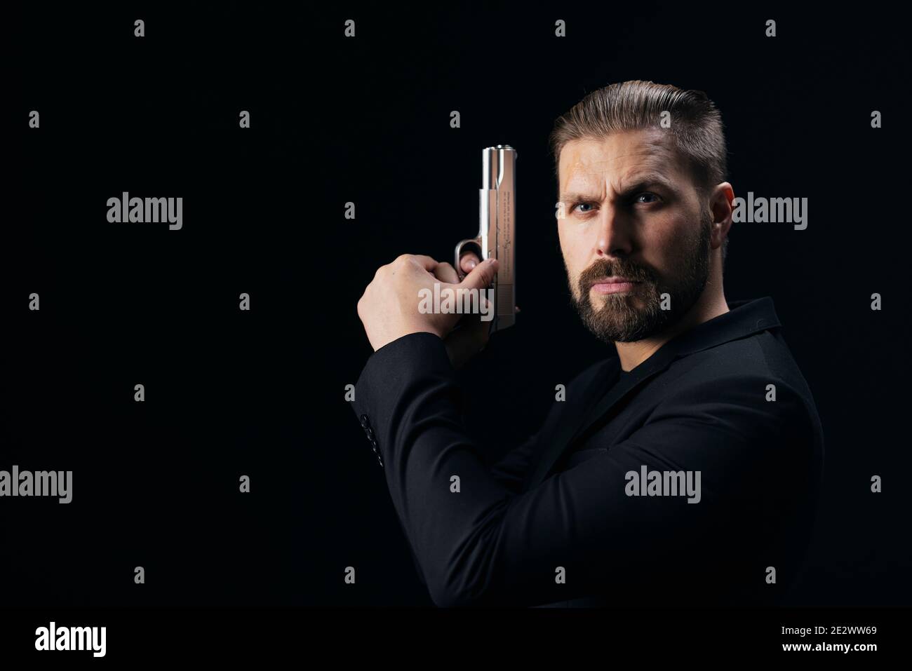 Aggressive bandit posing with weapon in hands Stock Photo - Alamy