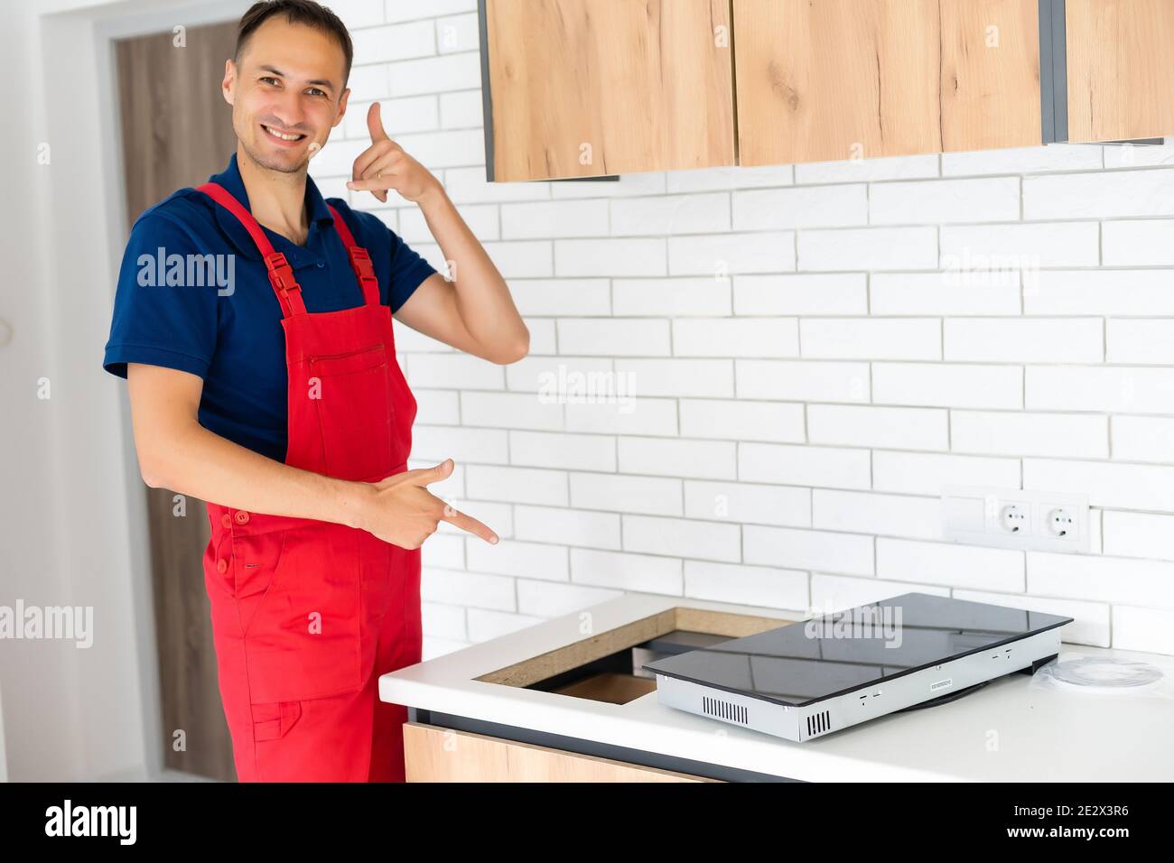 Installation of induction stove or cooktop by a master Stock Photo - Alamy