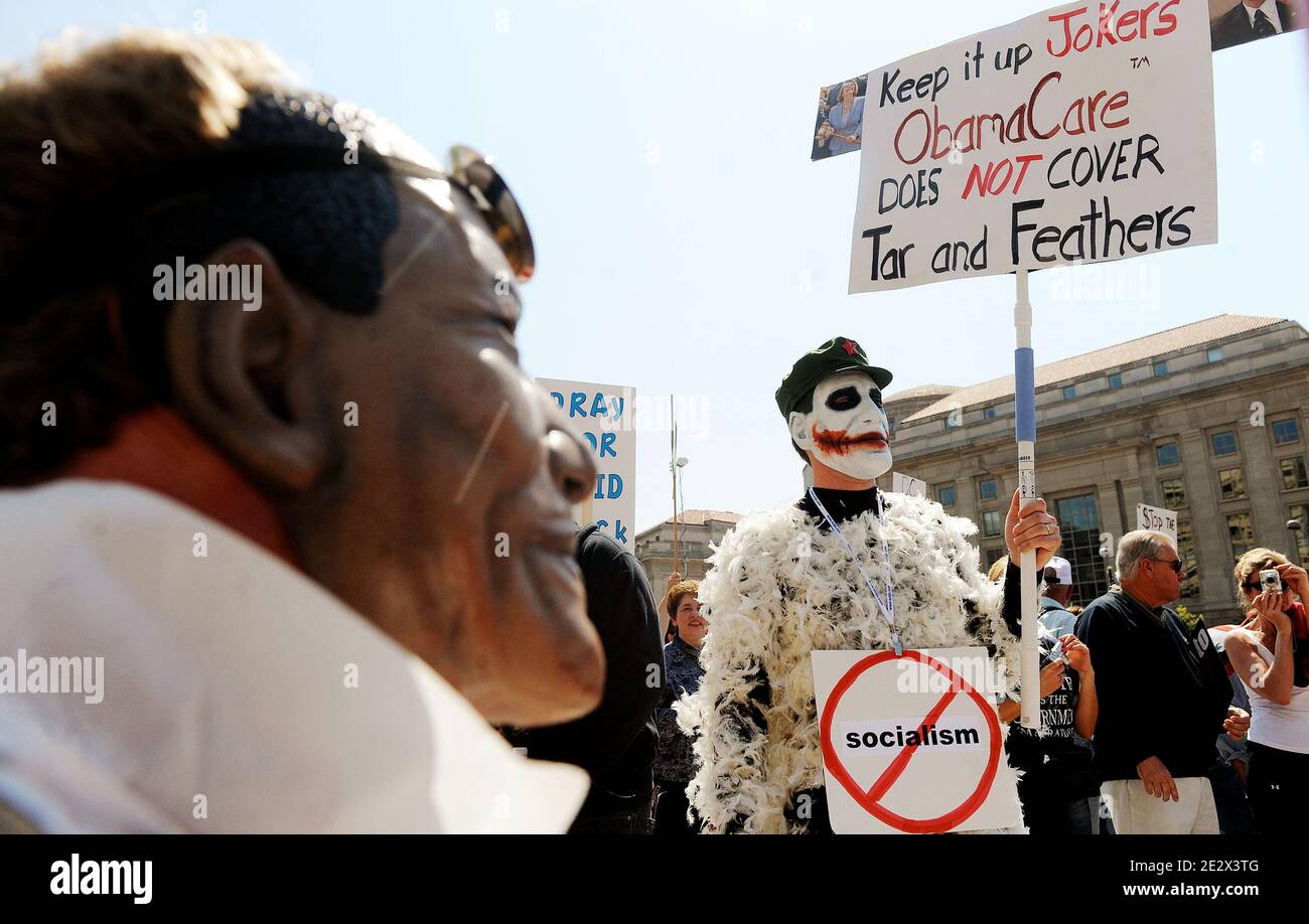 People hold signs during a Tea Party Protest in Freedom Plaza ...