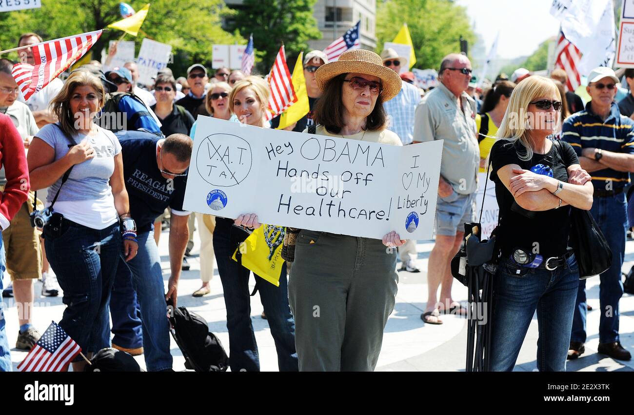 People hold signs during a Tea Party Protest in Freedom Plaza ...