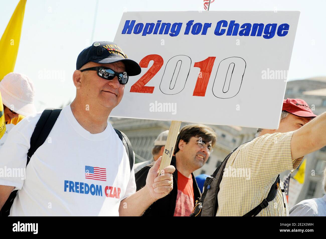 People hold signs during a Tea Party Protest in Freedom Plaza ...