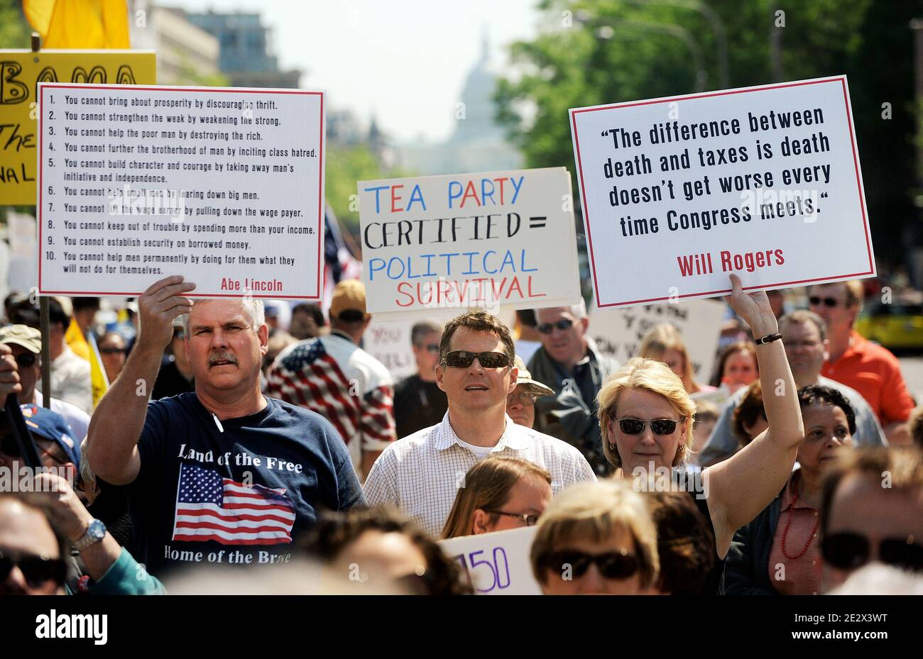 People hold signs during a Tea Party Protest in Freedom Plaza ...