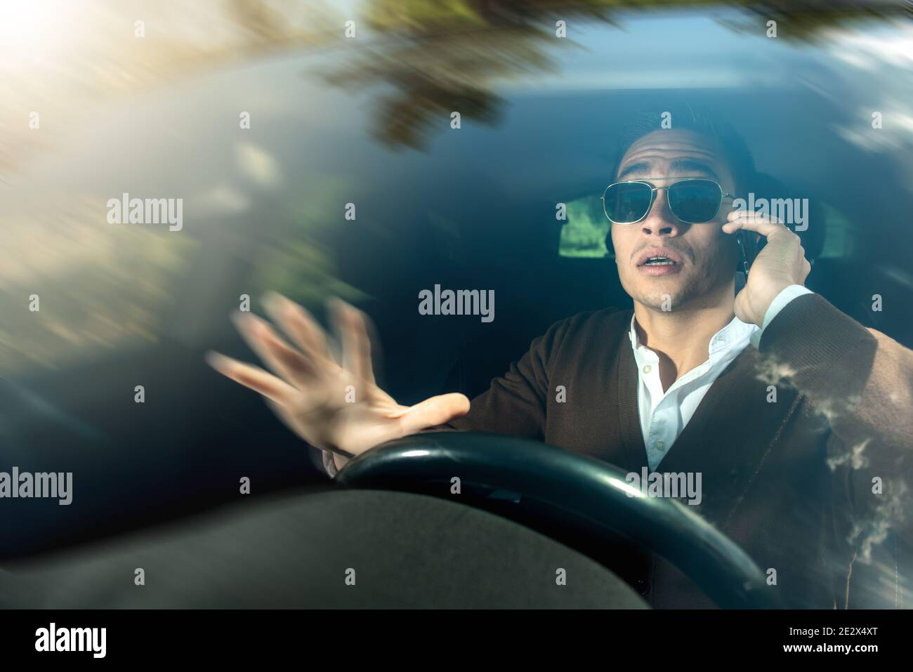 A man talking on phone during driving with a scared face - the concept ...