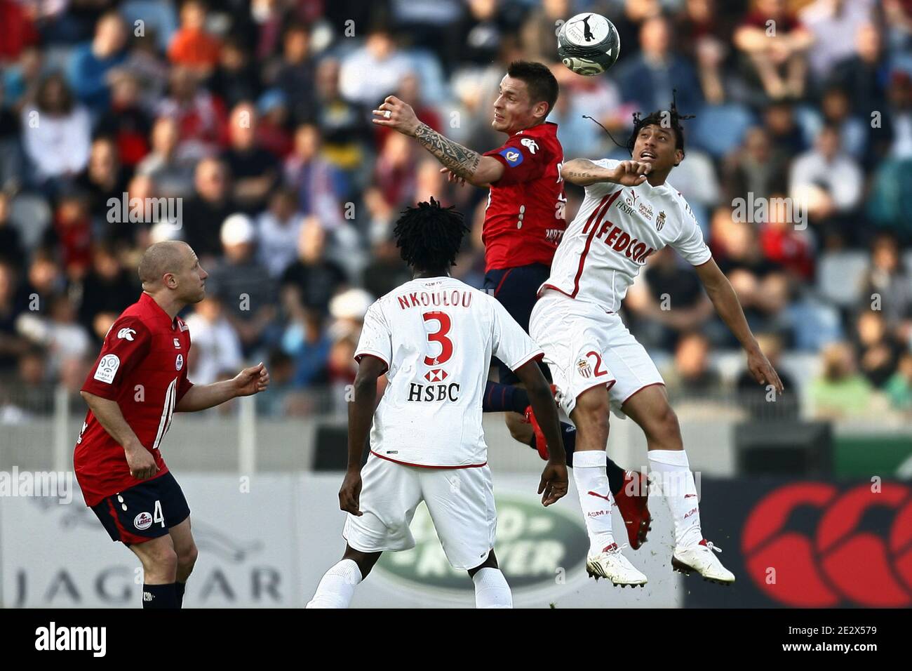 Lille's Mathieu Debuchy fights for the ball in air with Monaco's Juan ...