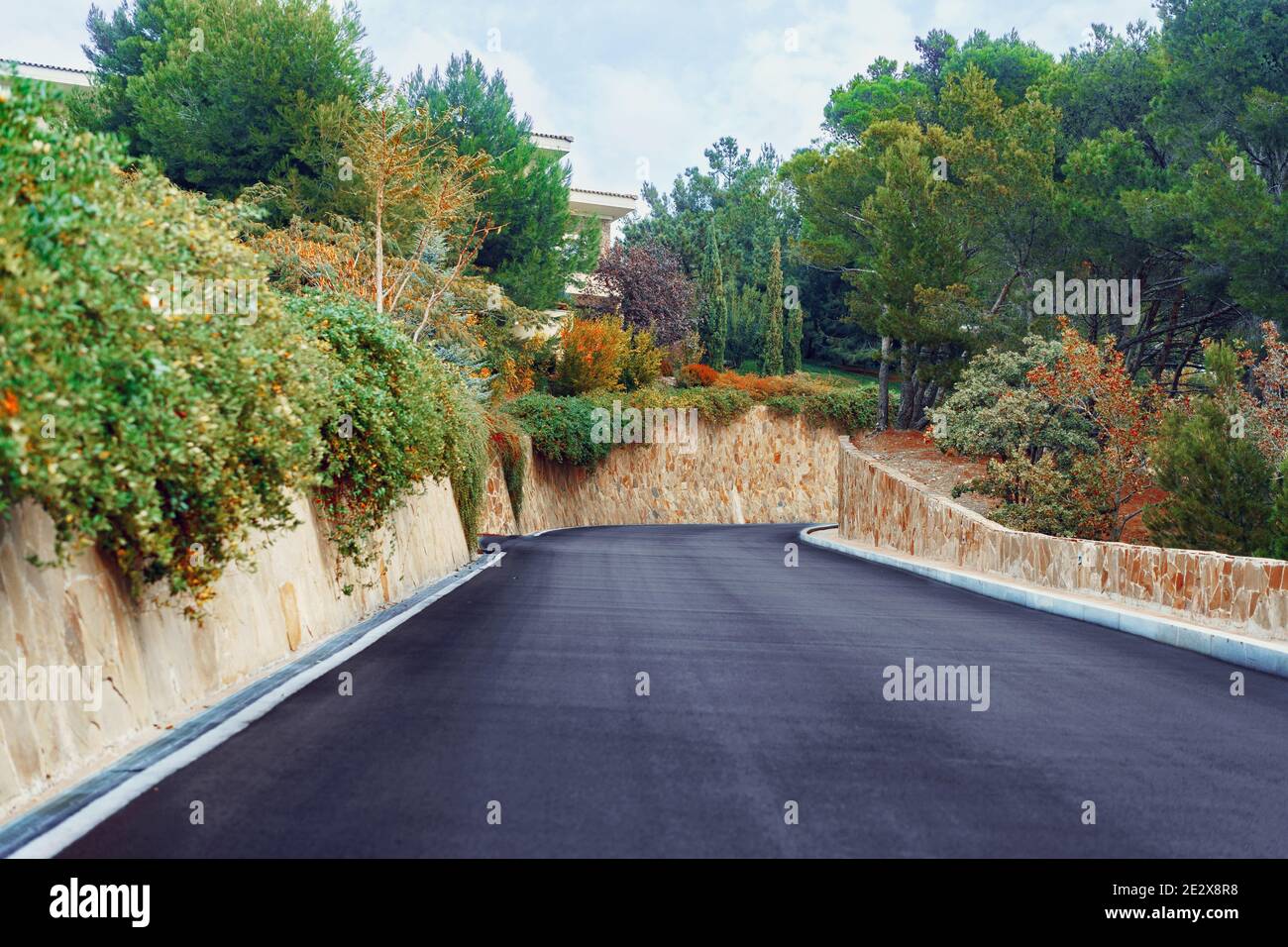 Picturesque concrete slope walkway with plants on the sides Stock Photo ...
