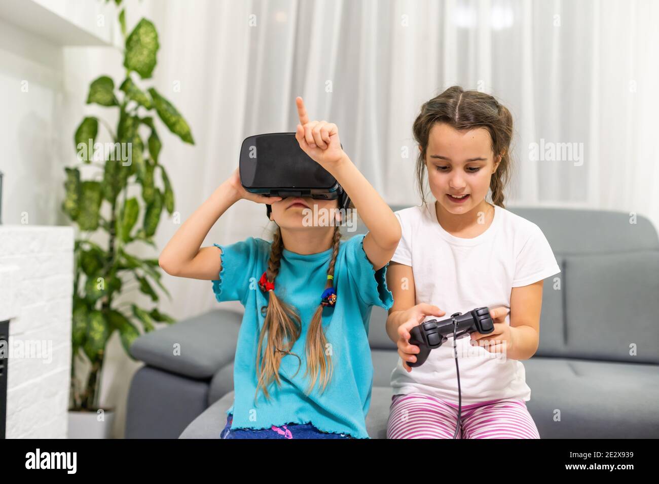two little girls using glasses of virtual reality headset. concept of ...