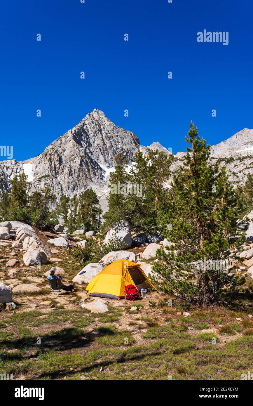 Backpacker and tent under the Sierra crest, John Muir Wilderness ...