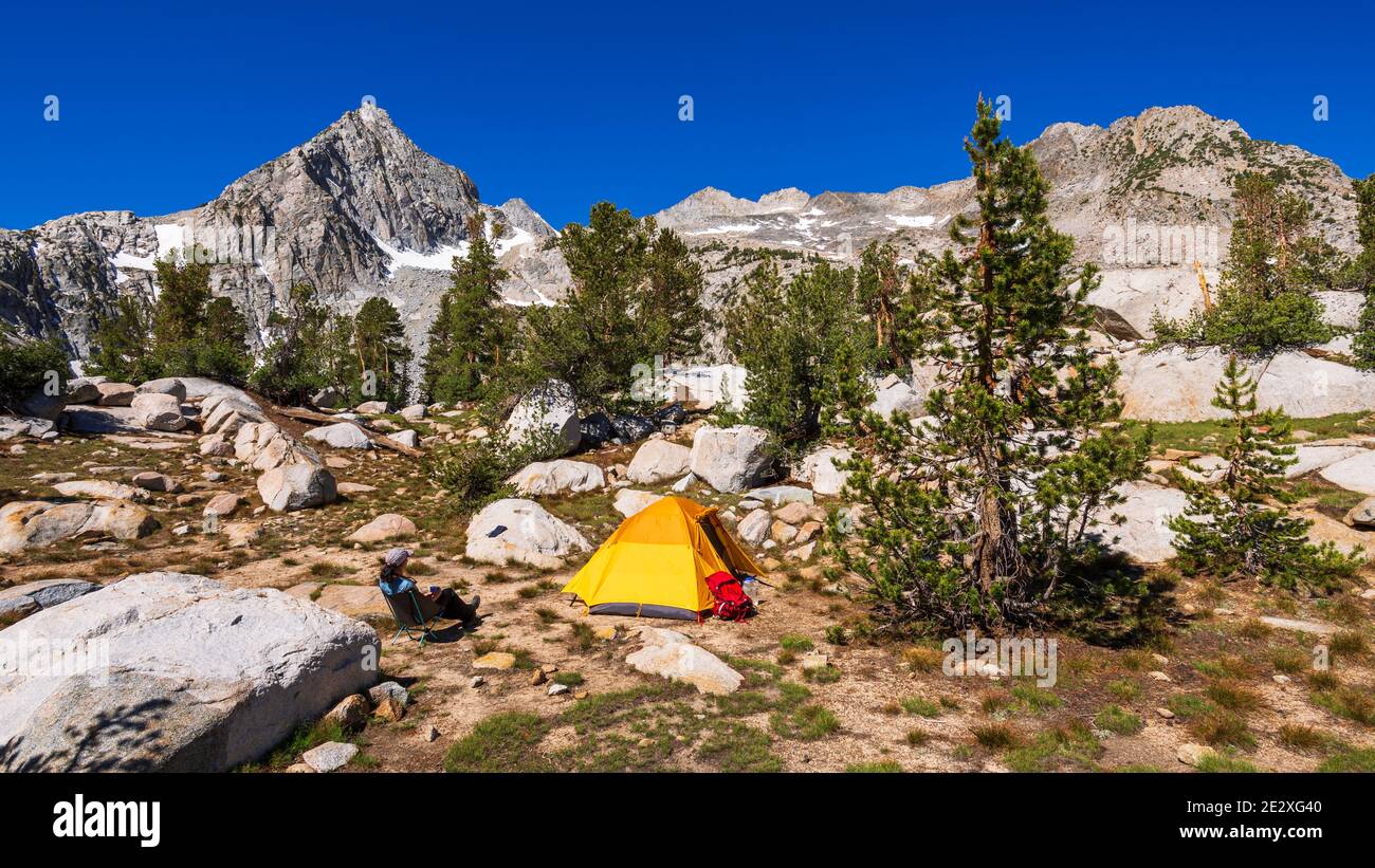 Backpacker and tent under the Sierra crest, John Muir Wilderness ...