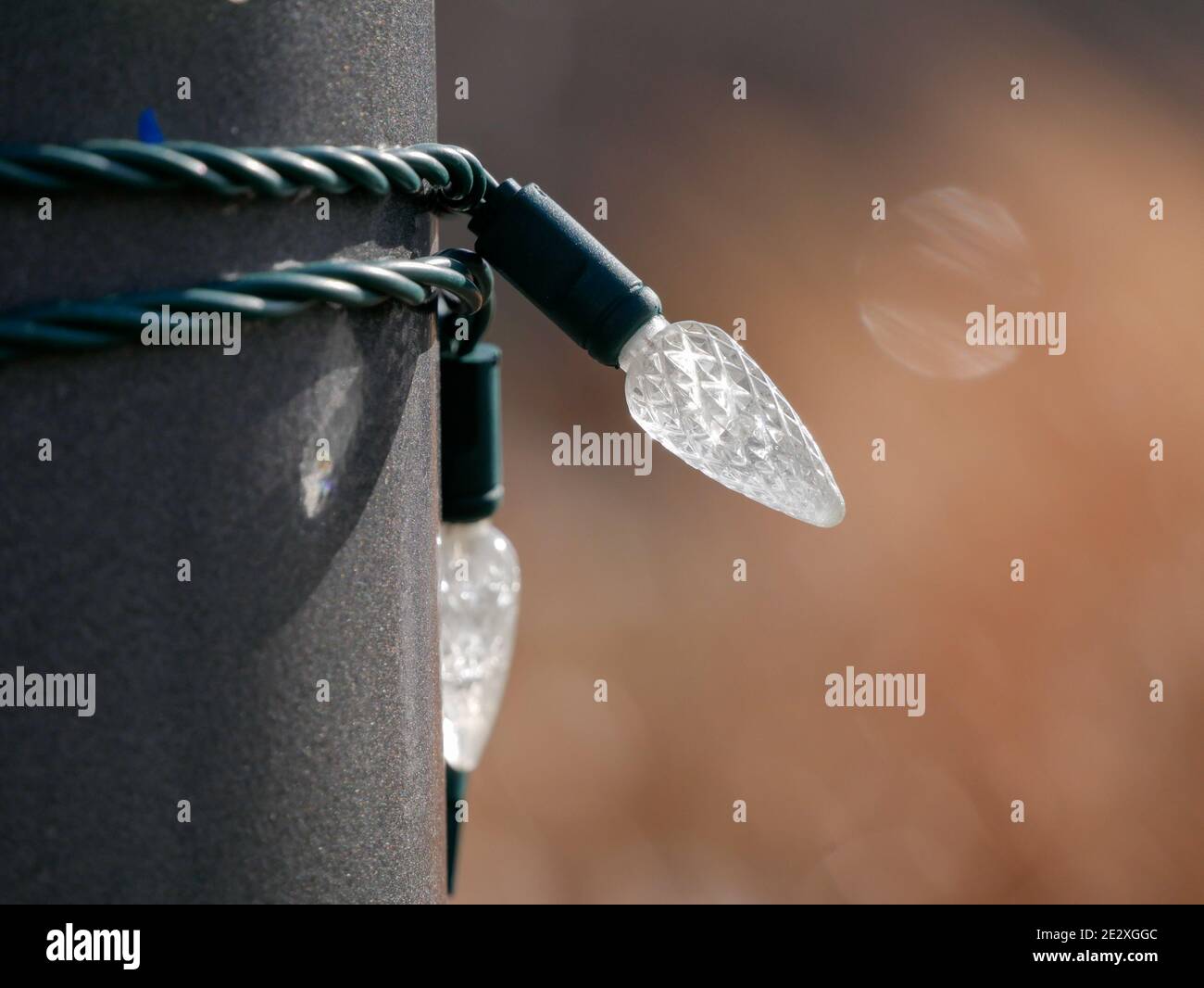 Clear holiday LED lights strung around light pole Stock Photo - Alamy