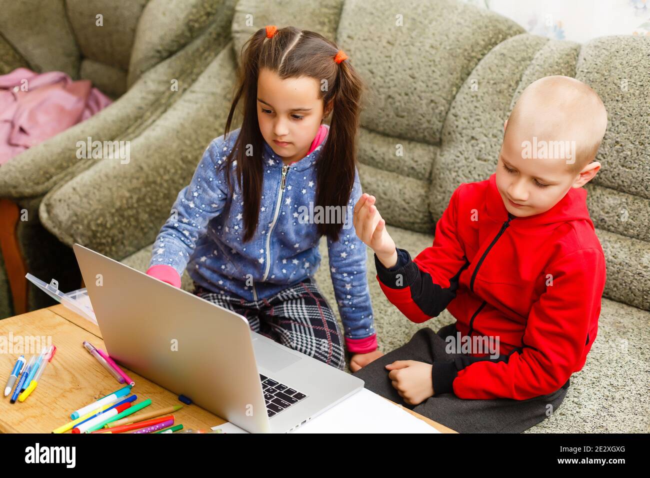 Distance learning online education. school boy and girl studying at ...