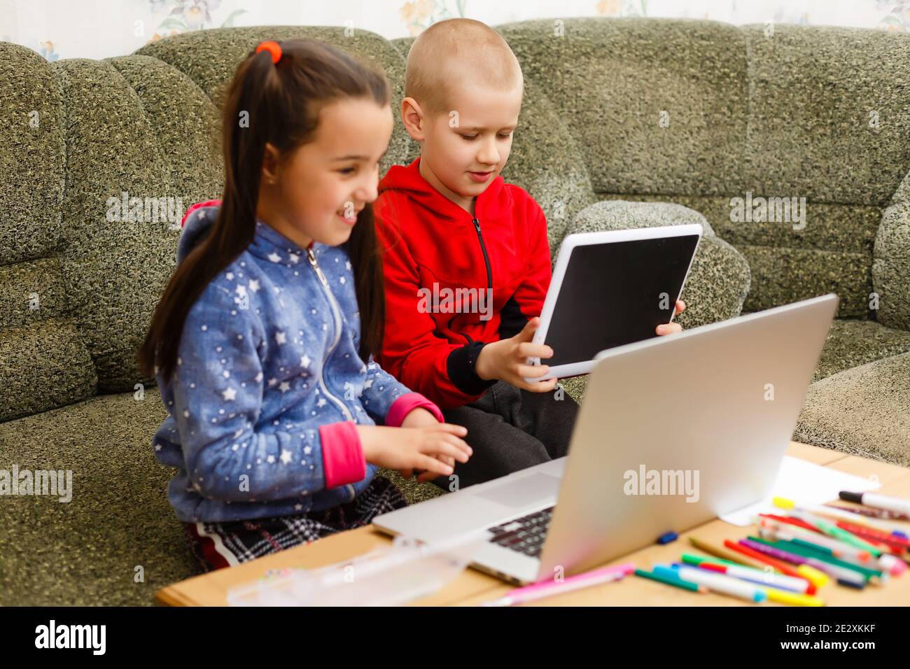 Distance learning online education. school boy and girl studying at ...