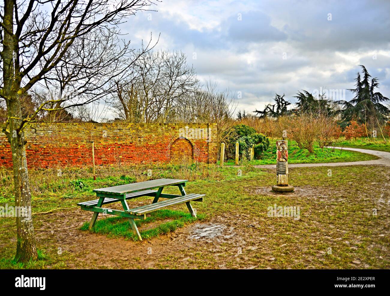 Bench and statue in park Stock Photo - Alamy