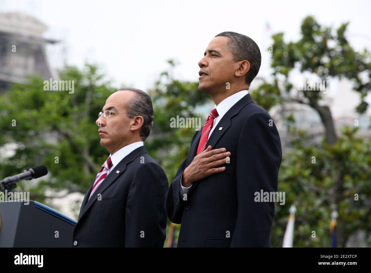 US President Barack Obama and Mexican President Felipe Calderon listen ...