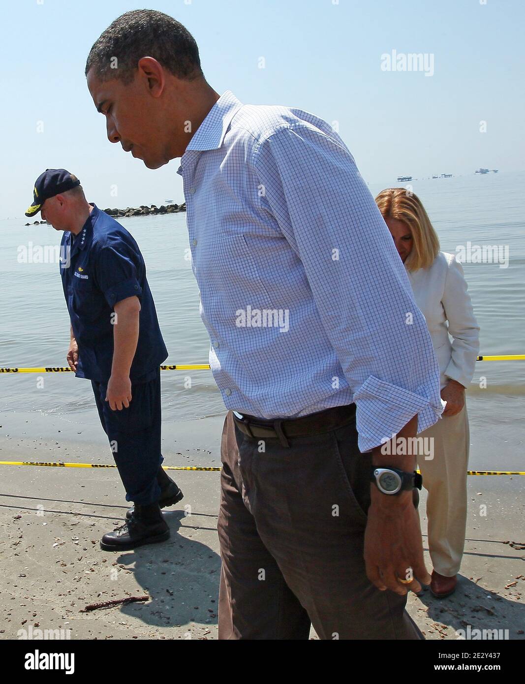 U.S. President Barack Obama (C) tours the beach at Port Fourchon with ...