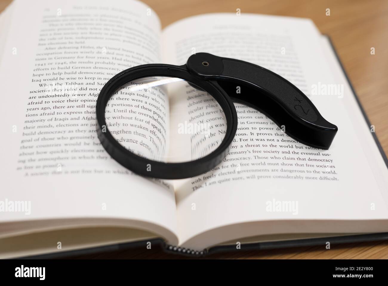 Open book with magnifying glass. Home Stock Photo - Alamy