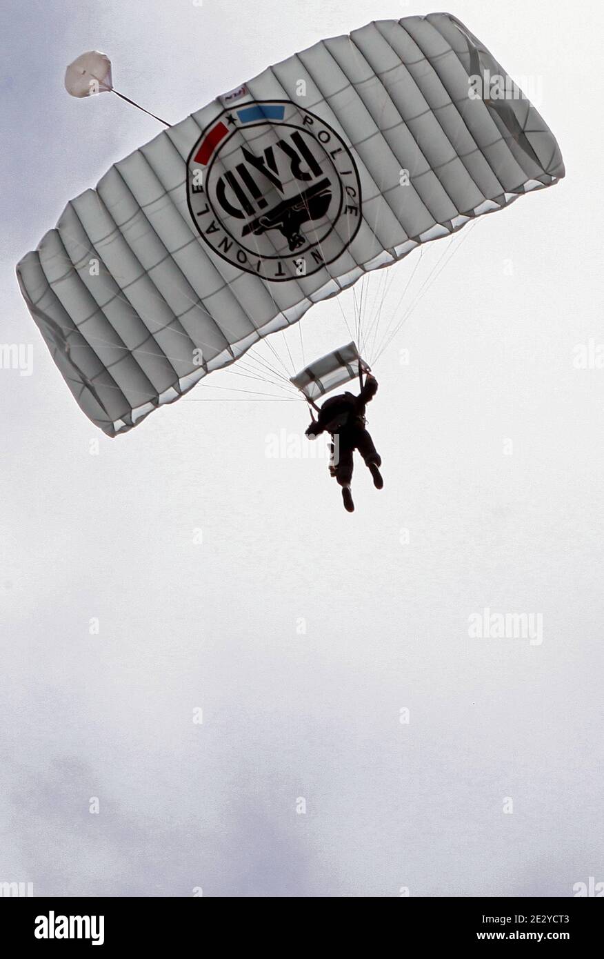 A member of the RAID makes a parachute jumping during a ceremony ...