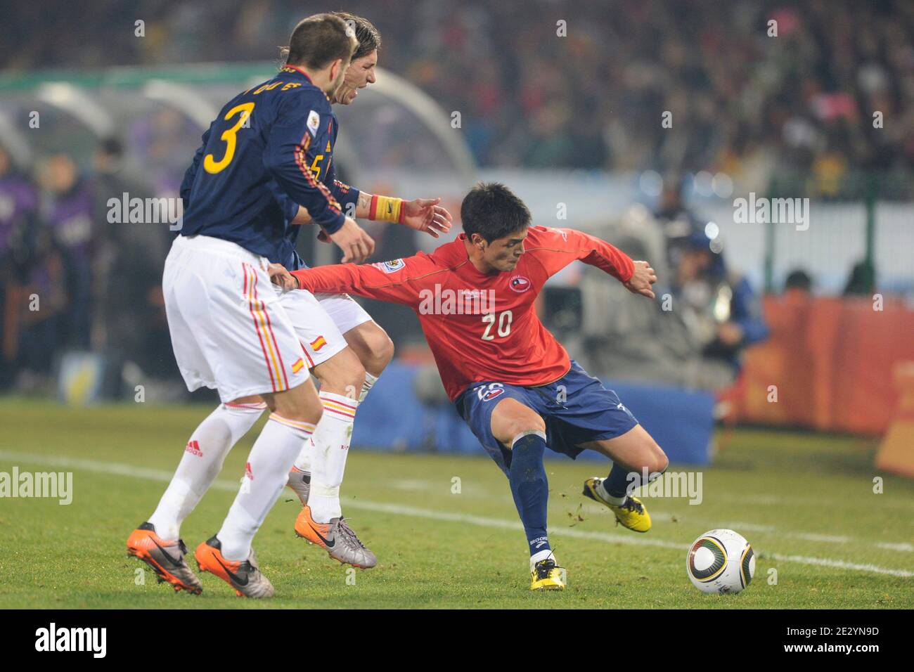 Spain's Gerard Pique and Sergio Ramos battles Chile's Rodrigo Millar ...