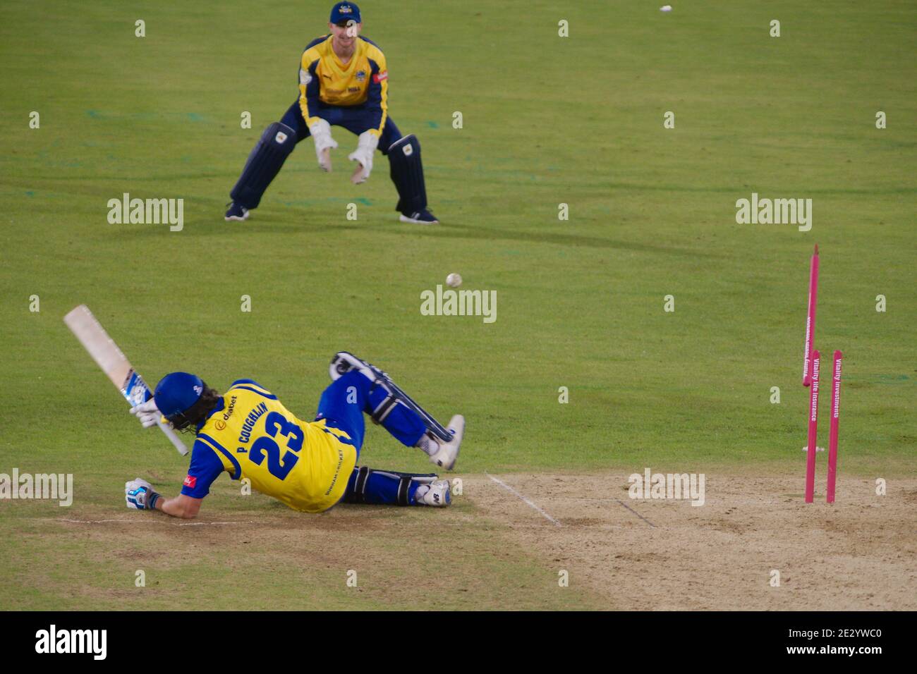 Paul Coughlin, batting for Durham Cricket, falling over as he is bowled ...