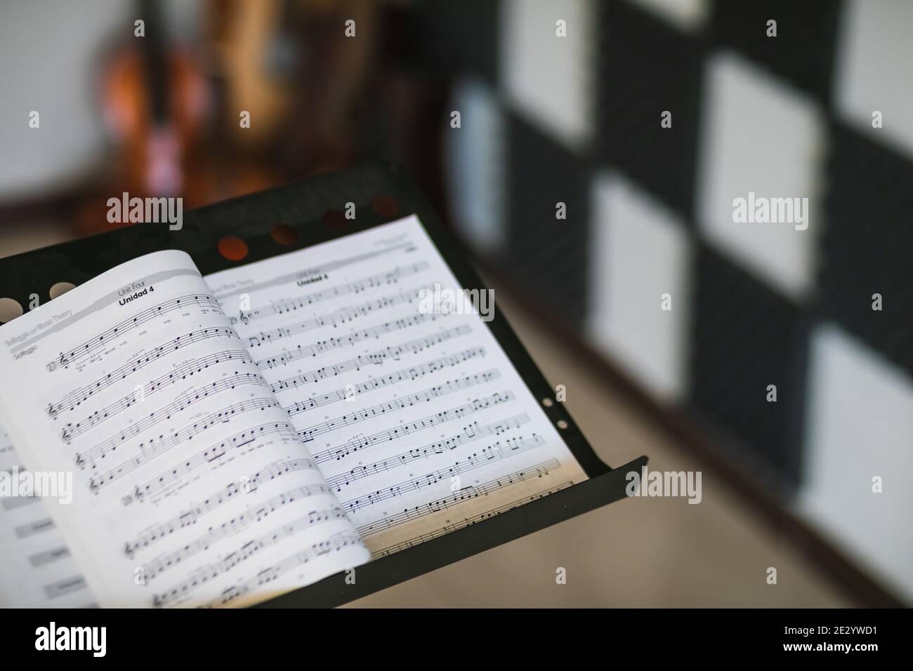 High angle shot of music note sheets on a stand with a blurry ...
