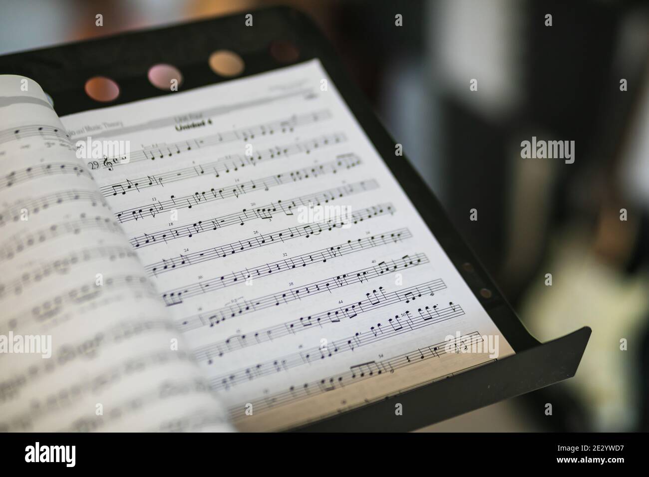 Closeup of music note sheets on a stand with a blurry backgr Stock ...