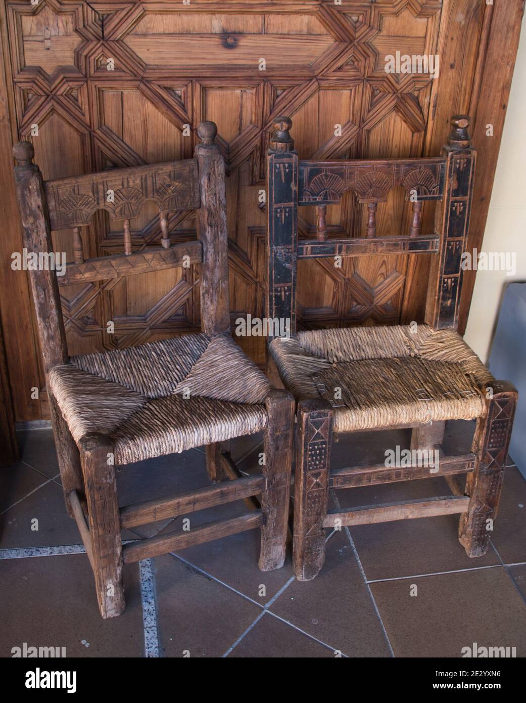 Vertical shot of two wooden chairs near the wooden door Stock Photo - Alamy
