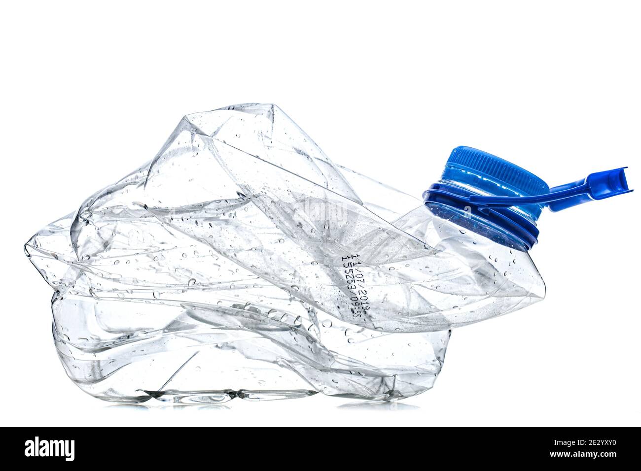 smashed empty plastic bottle with blue cap, isolated on white ...