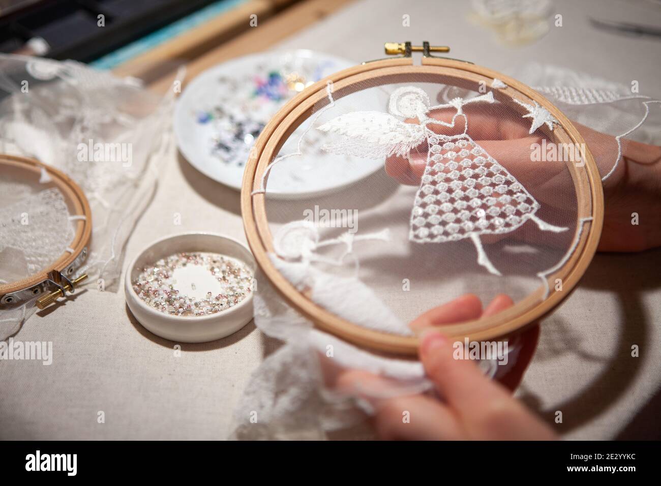 Workplace of an embroiderer with embroidery frames, angel embroidery ...