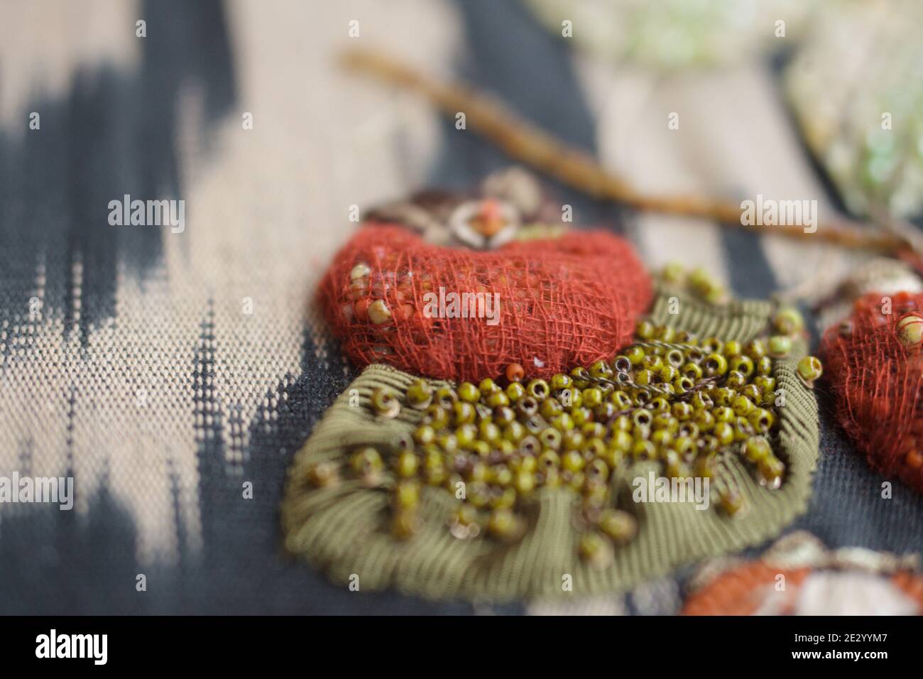 Couture embroidery of persimmon on ikat fabric. Still life with fruits ...