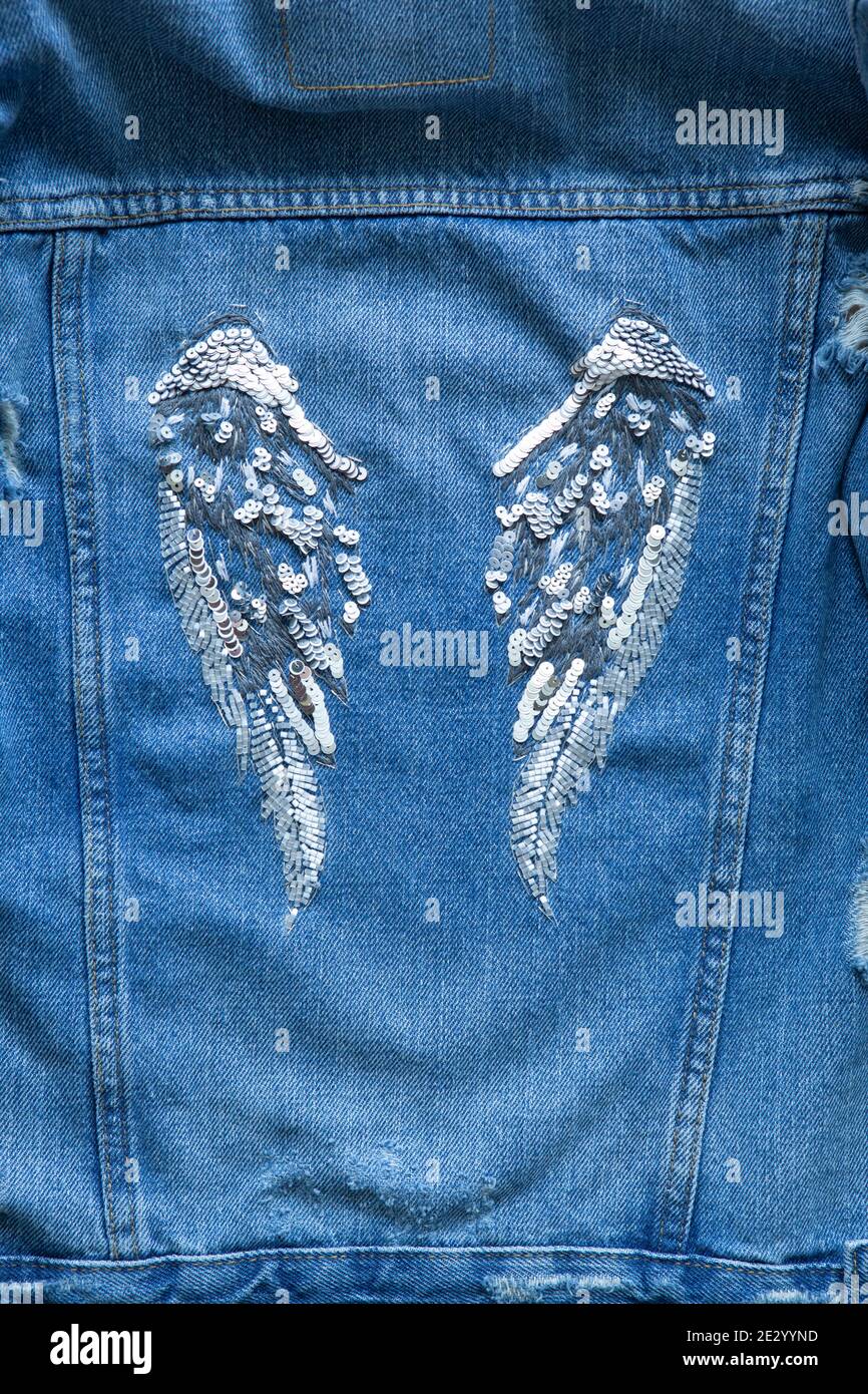 Couture embroidery of wings on denim jacket Stock Photo - Alamy