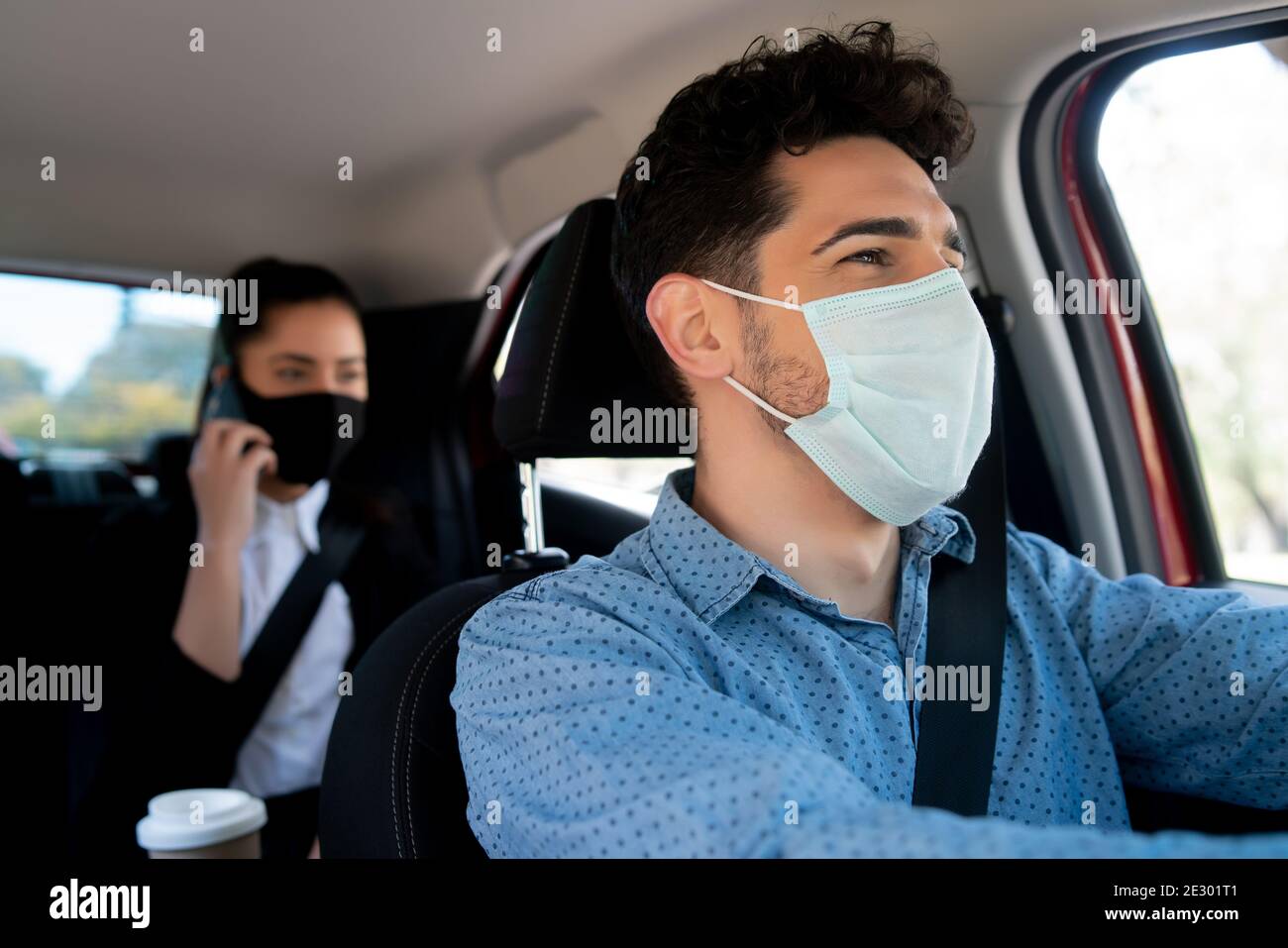Taxi driver with passenger at back seat Stock Photo - Alamy