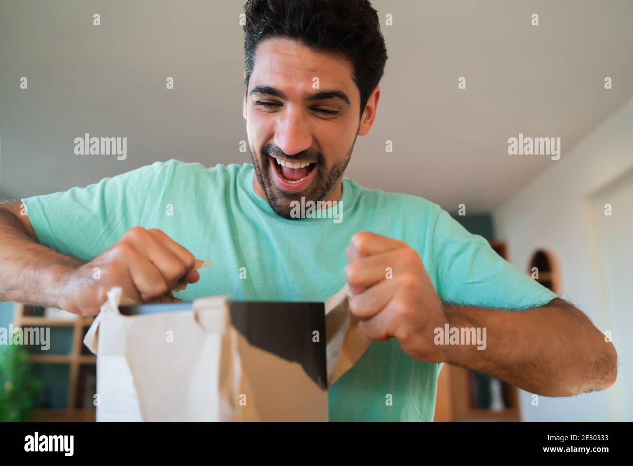 Surprised man looking open gift box hi-res stock photography and images ...