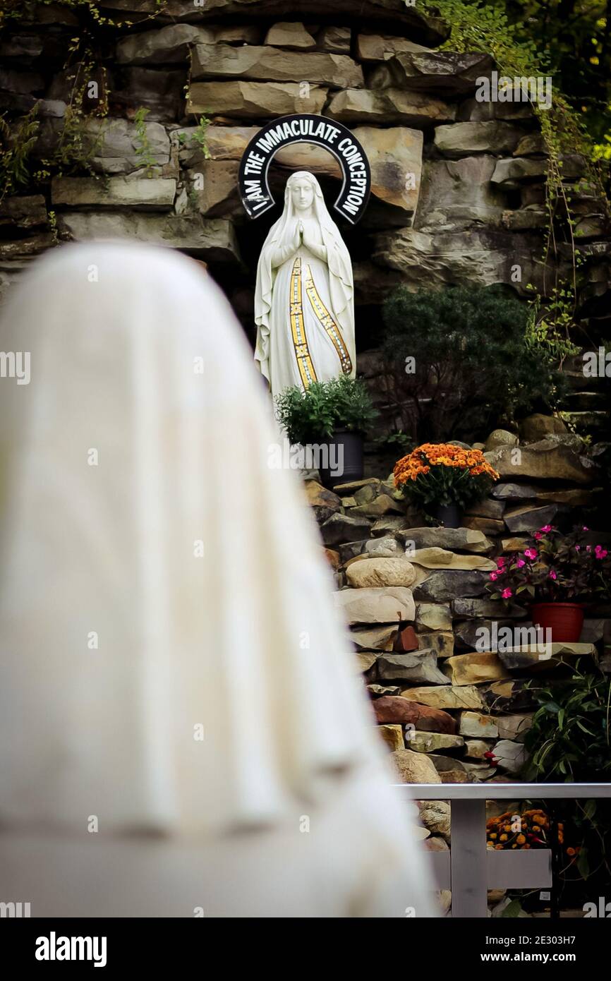Vertical closeup of a female kneeling in front of the Immaculate ...