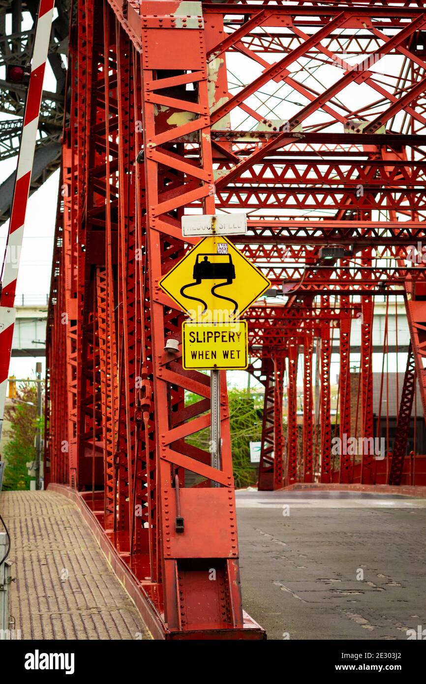 Vertical closeup of the "SLIPPERY WHEN WET" signage in the bridge Stock ...