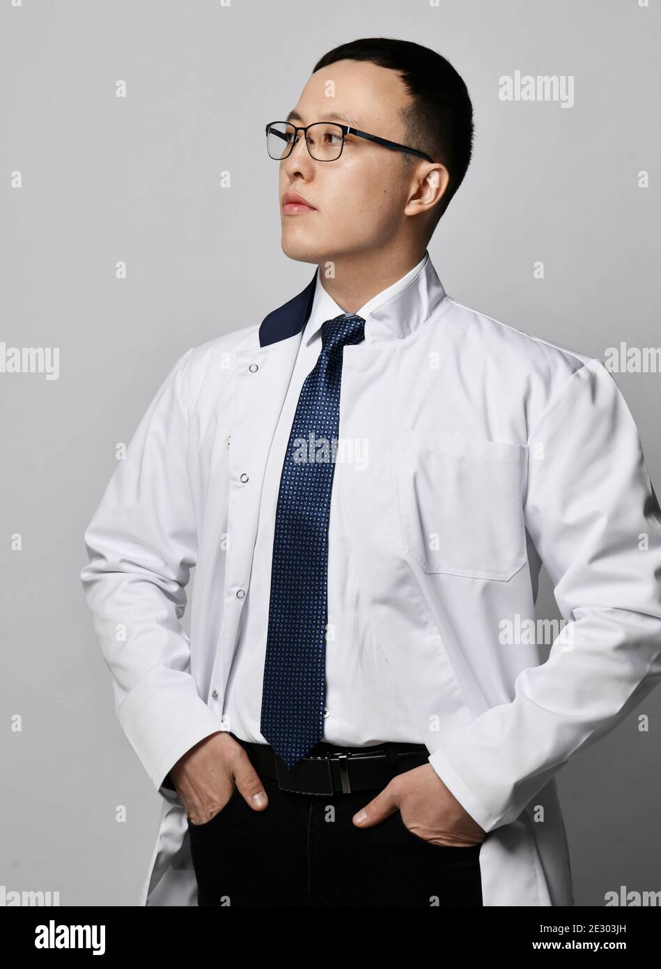 Portrait of young man doctor in glasses, medical gown uniform, white ...