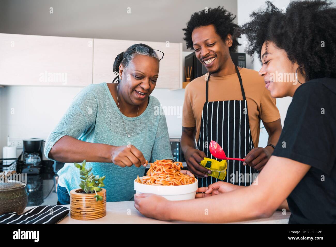 Portrait of family cook together at home Stock Photo - Alamy
