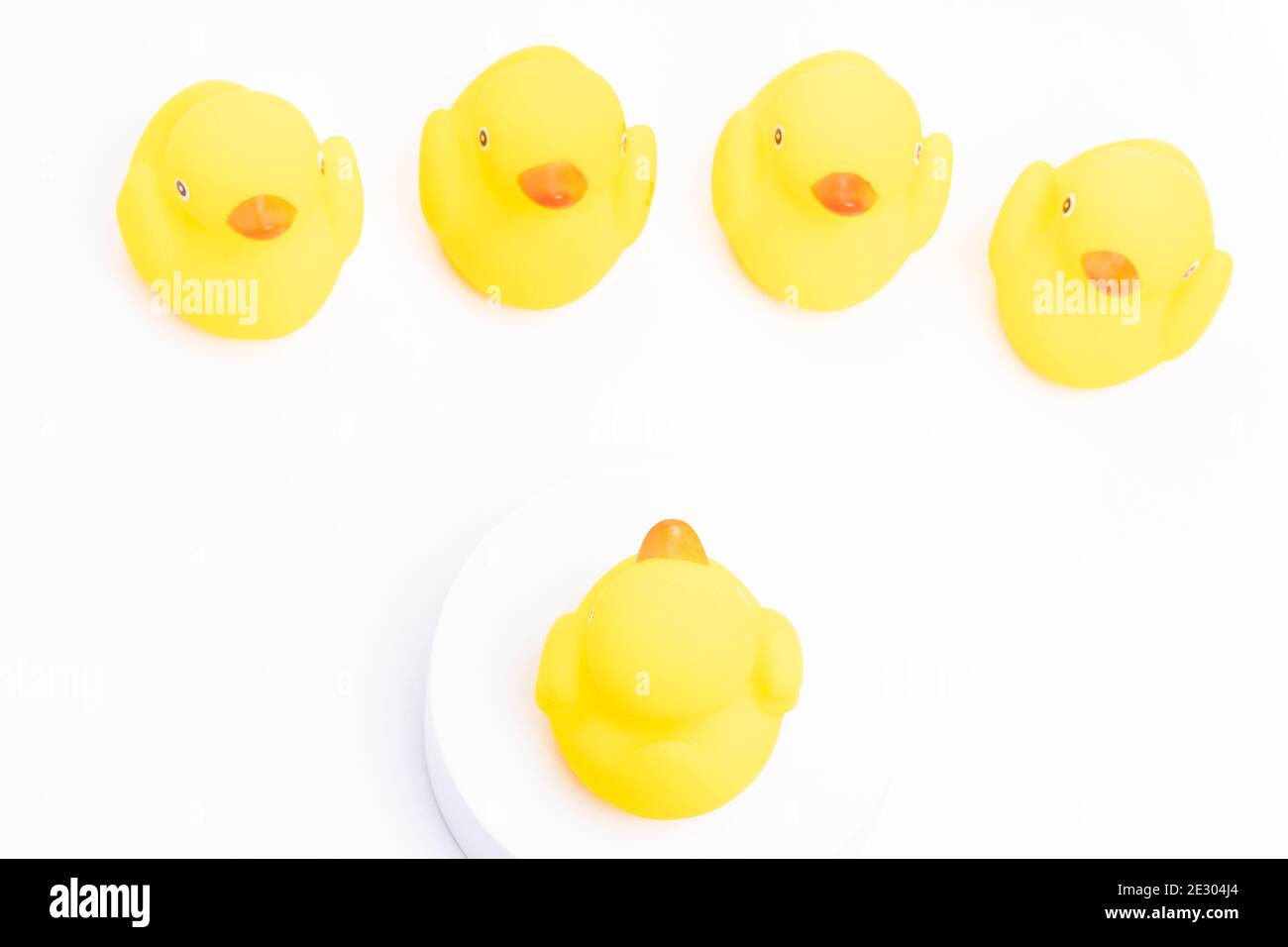 Leadership concept. A group of yellow rubber duck following the leader ...