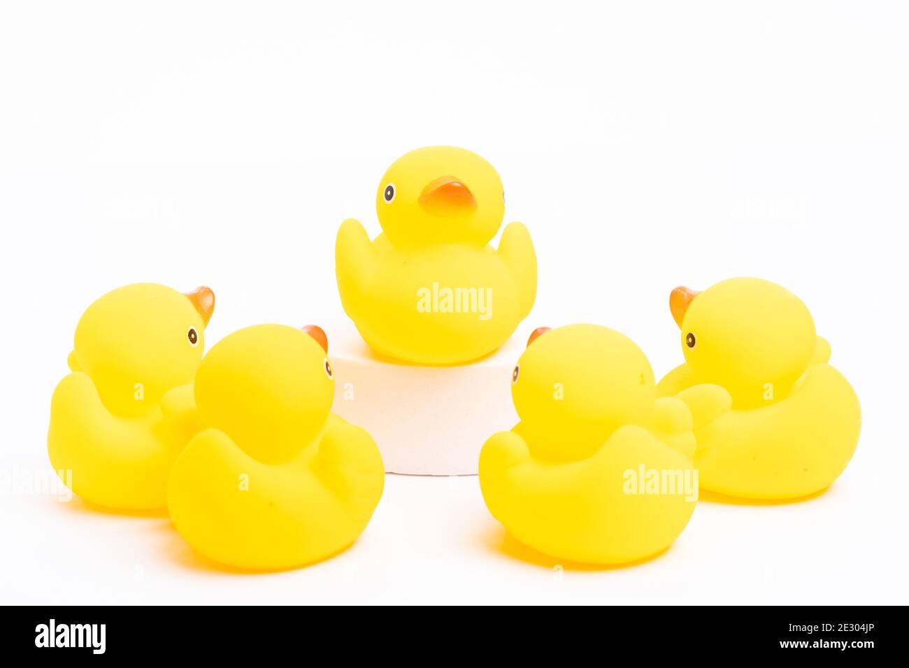 Leadership concept. A group of yellow rubber duck following the leader ...