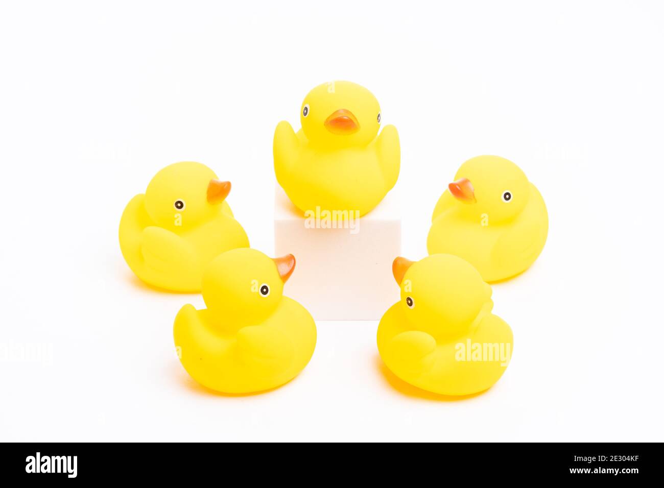Leadership concept. A group of yellow rubber duck following the leader ...