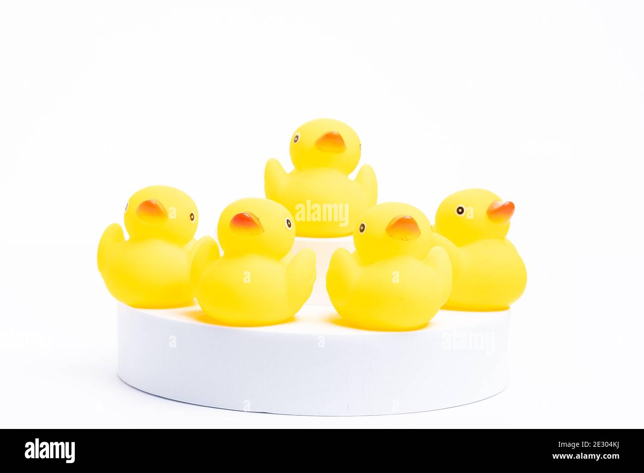 Leadership concept. A group of yellow rubber duck following the leader ...