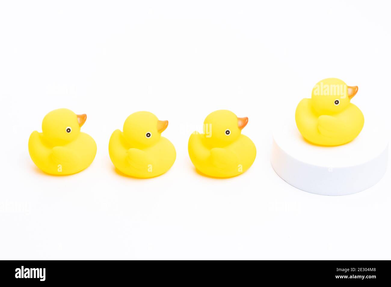Leadership concept. A group of yellow rubber duck following the leader ...