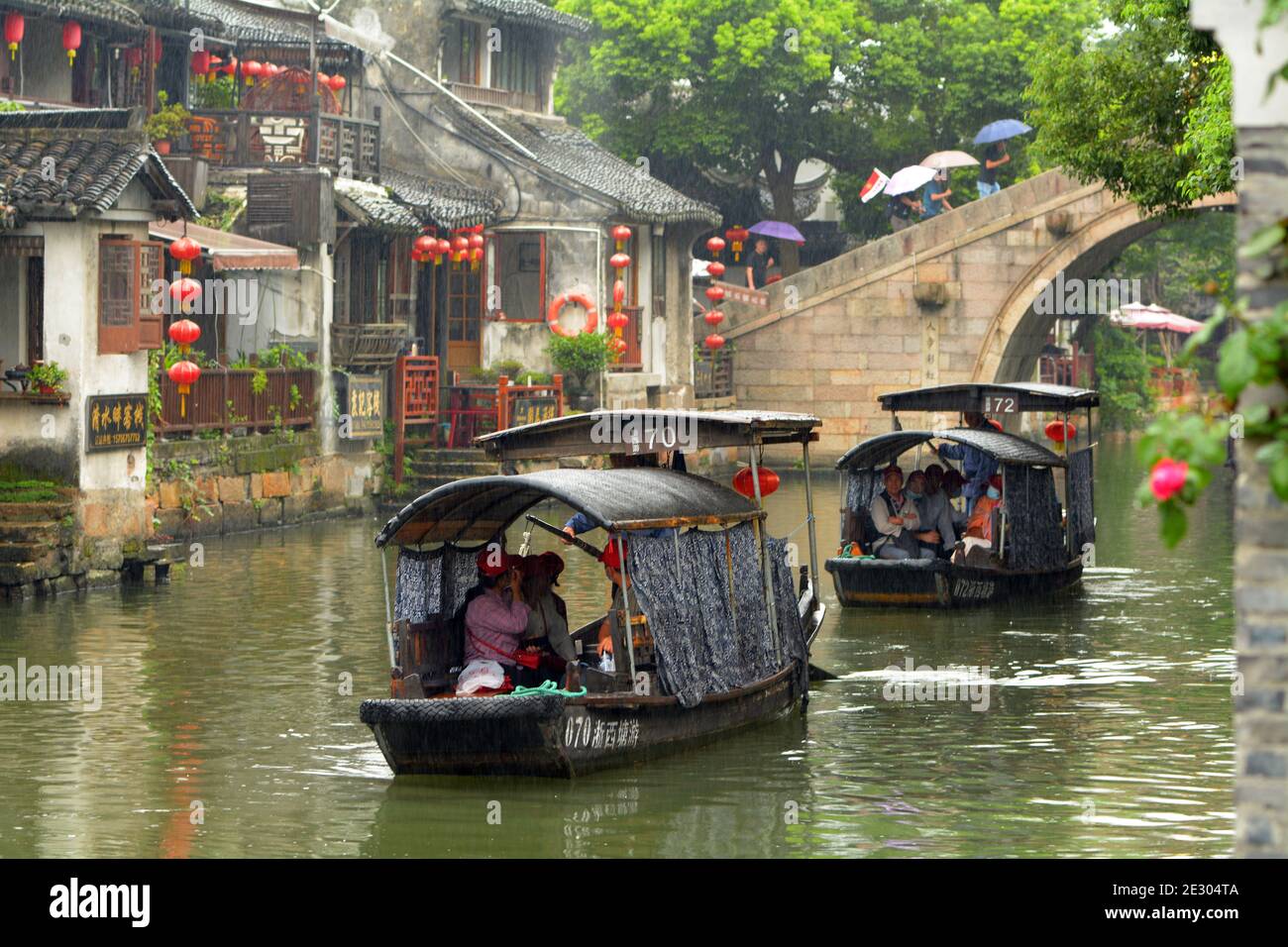 Tourist boats in Xitang take tourists along the ancient canal ...