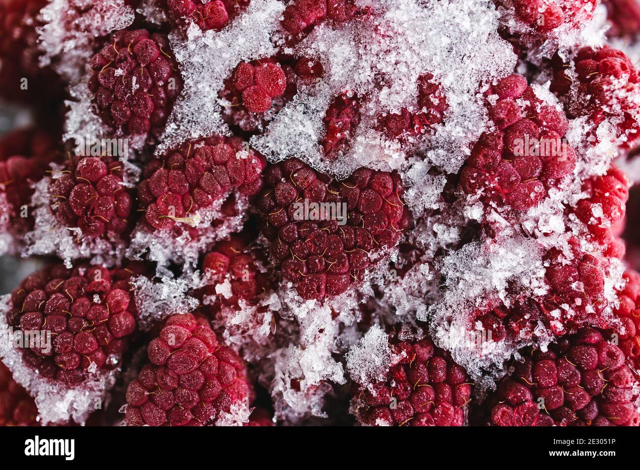 simple food ingredients concept, close-up of frozen raspberries with ...