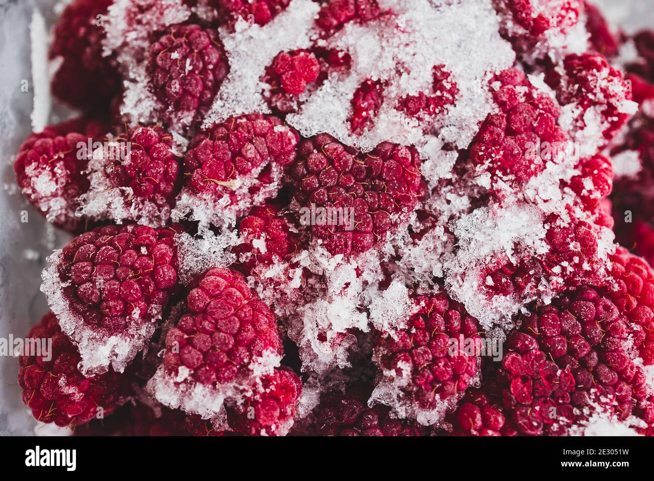 simple food ingredients concept, close-up of frozen raspberries with ...
